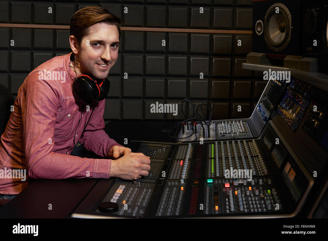 Engineer Working At Mixing Desk In Recording Studio Stock Photo - Alamy