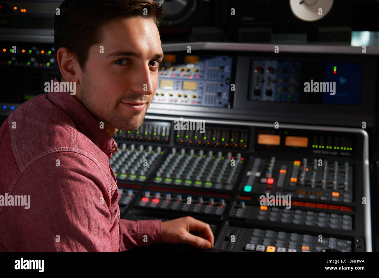 Engineer Working At Mixing Desk In Recording Studio Stock Photo - Alamy