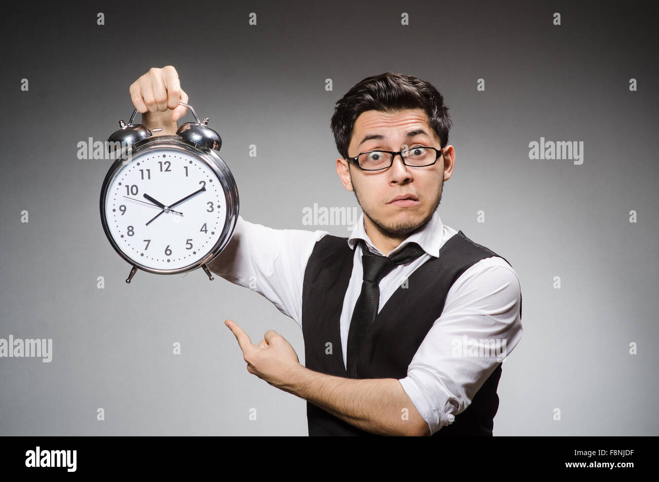 Businessman with clock in time concept Stock Photo - Alamy