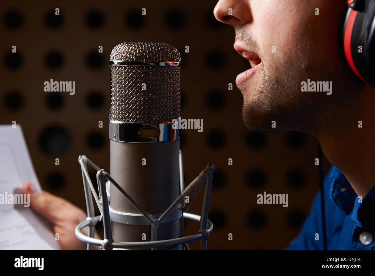 Man Holding Notes And Talking Into Studio Microphone Stock Photo - Alamy
