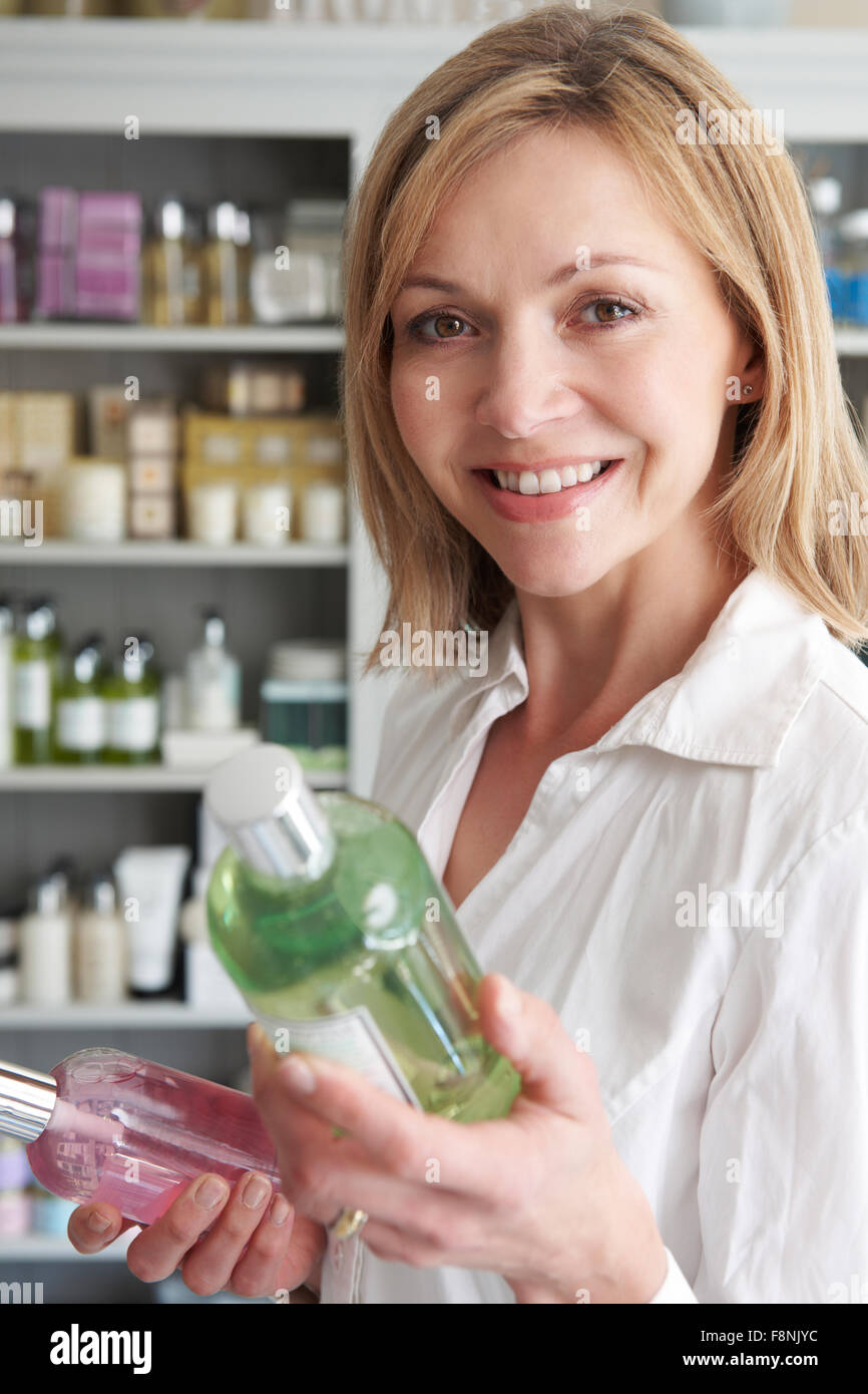 Female Customer In Shop Choosing Beauty Products Stock Photo - Alamy