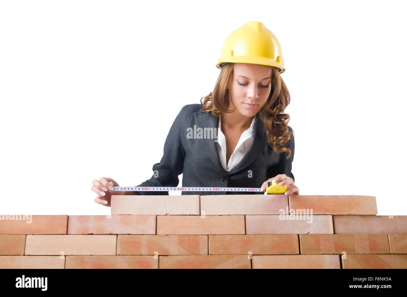 Woman builder measuring isolated on the white Stock Photo - Alamy