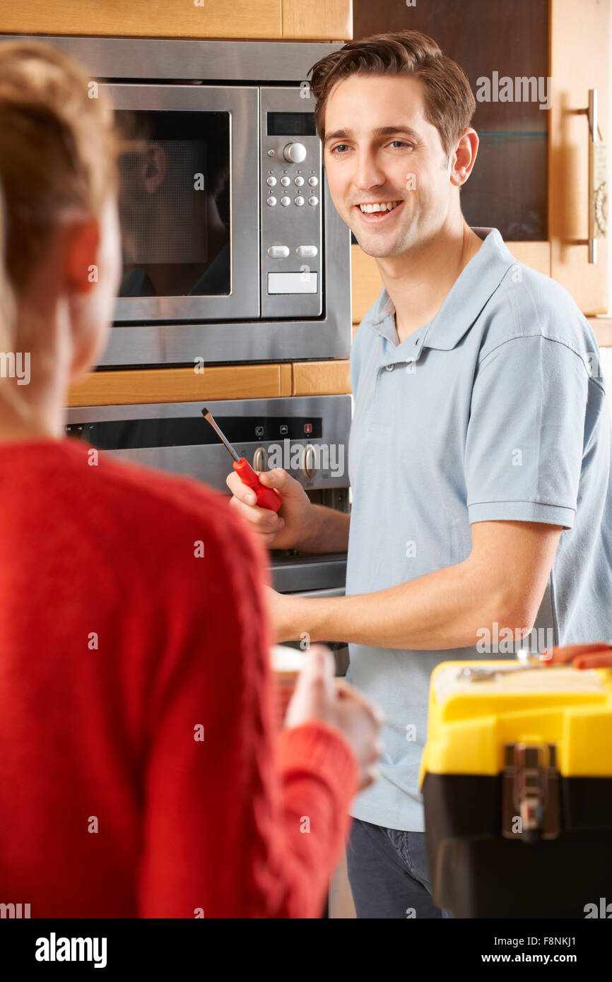 Engineer Giving Woman Advice On Kitchen Repair Stock Photo - Alamy
