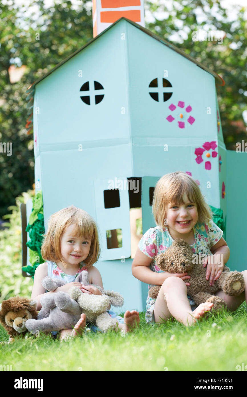 Two Children Playing In Home Made Cardboard House Stock Photo - Alamy