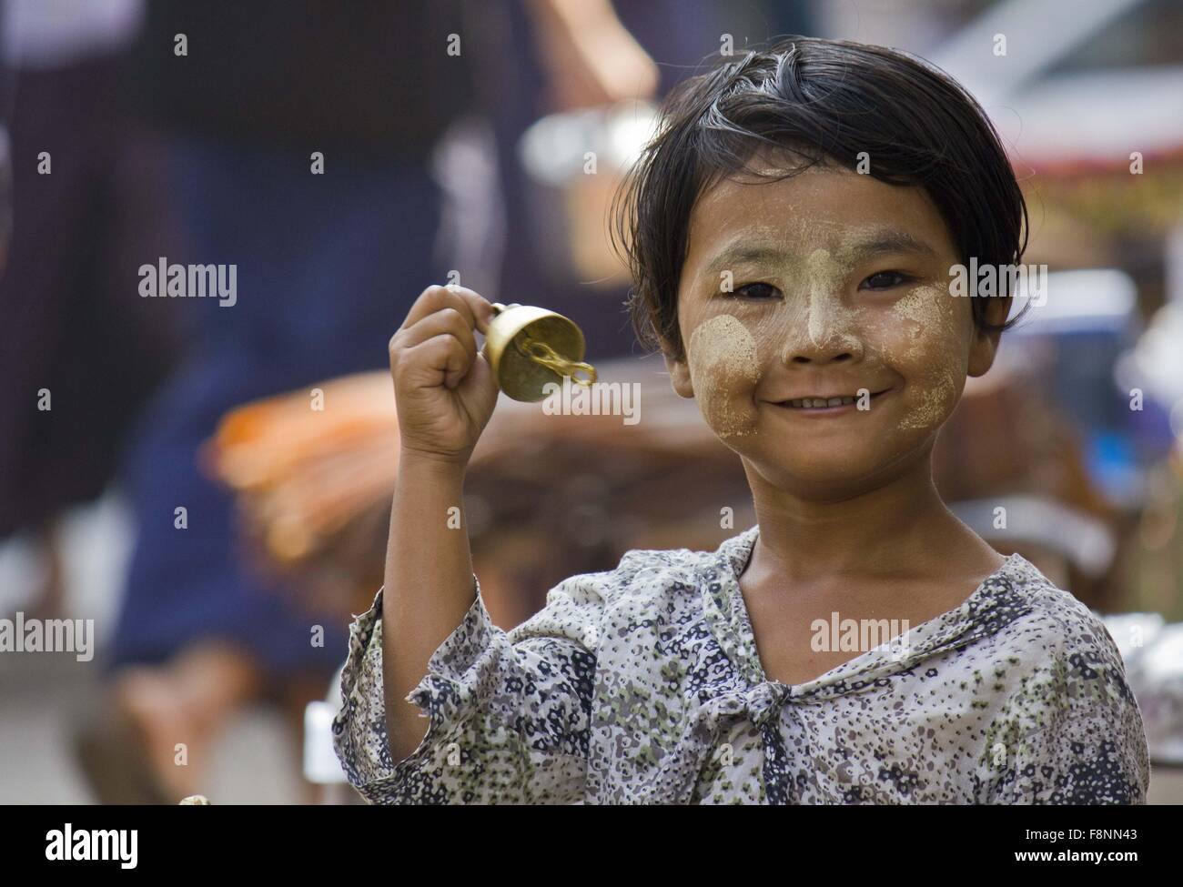 Young Bells seller. A young girl selling bells in the street of Yangoon ...