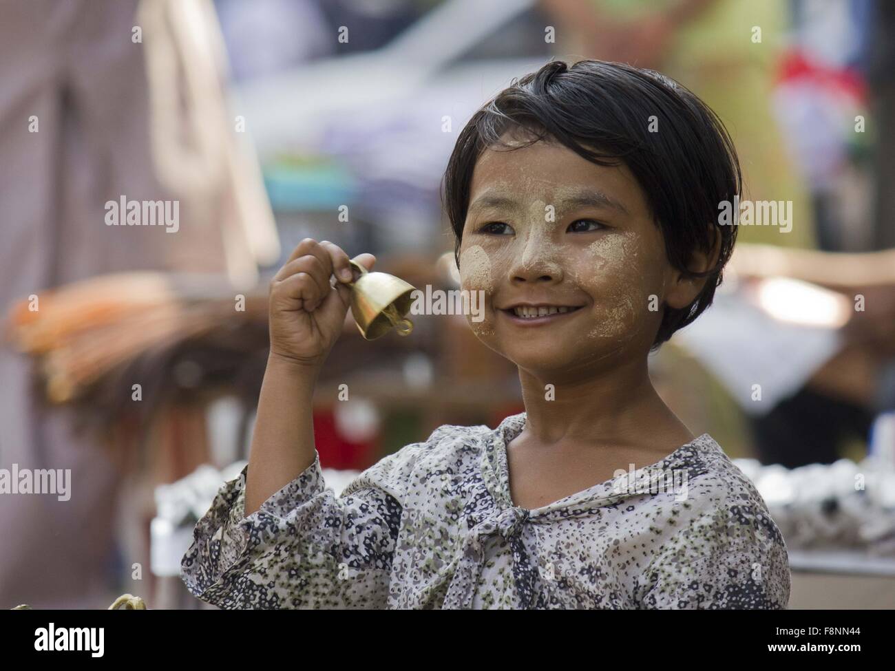 Young Bells seller. A young girl selling bells in the street of Yangoon ...