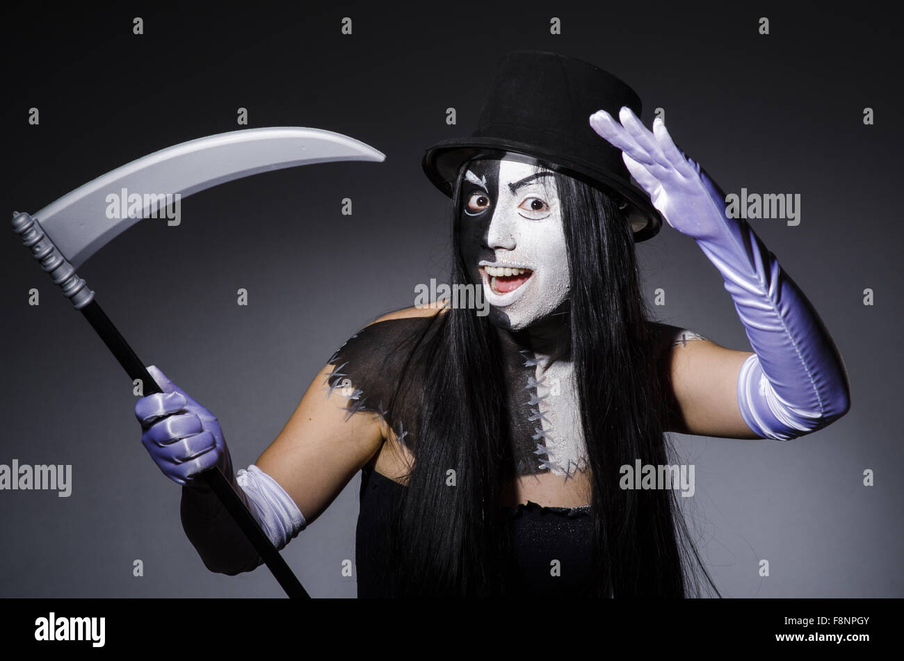Woman in halloween concept with scythe Stock Photo - Alamy