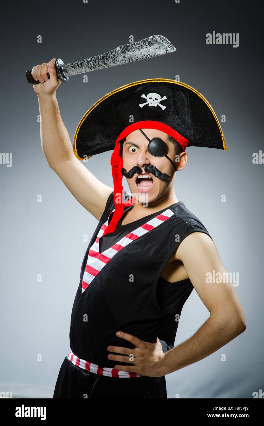 Funny pirate in the dark studio Stock Photo - Alamy