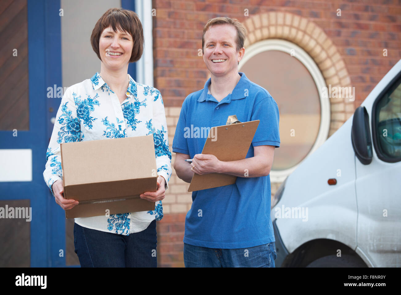 Customer Signing For Delivery From Courier Stock Photo - Alamy