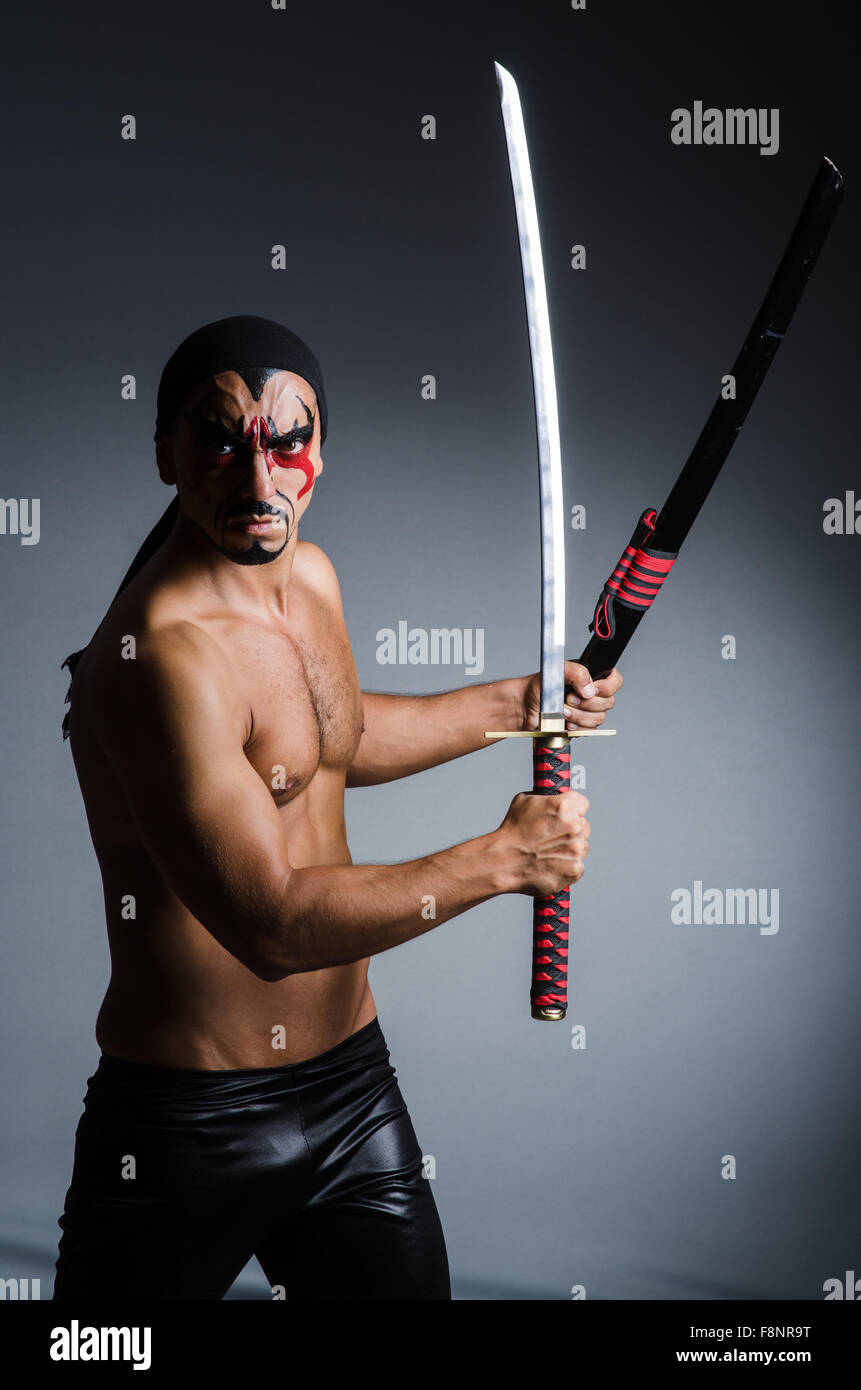 Man with sword and face paint Stock Photo - Alamy