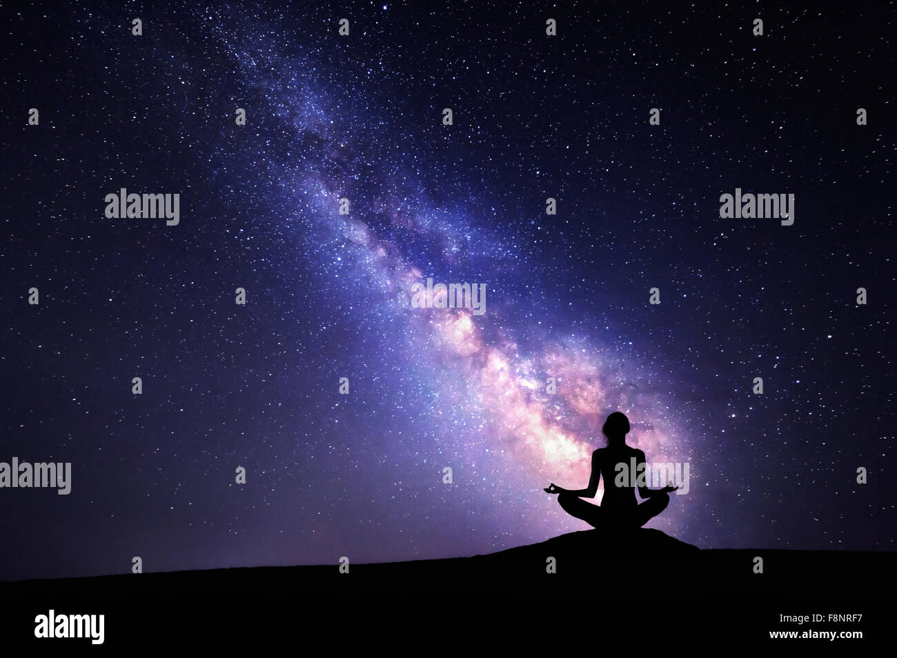 Milky Way. Night sky with stars and silhouette of a woman practicing ...
