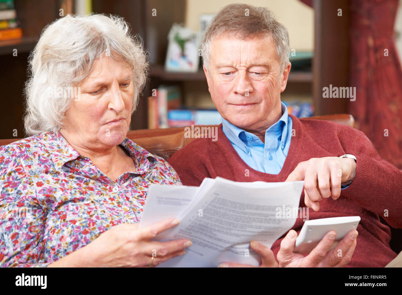 Worried Senior Couple Looking At Bills Together Stock Photo - Alamy