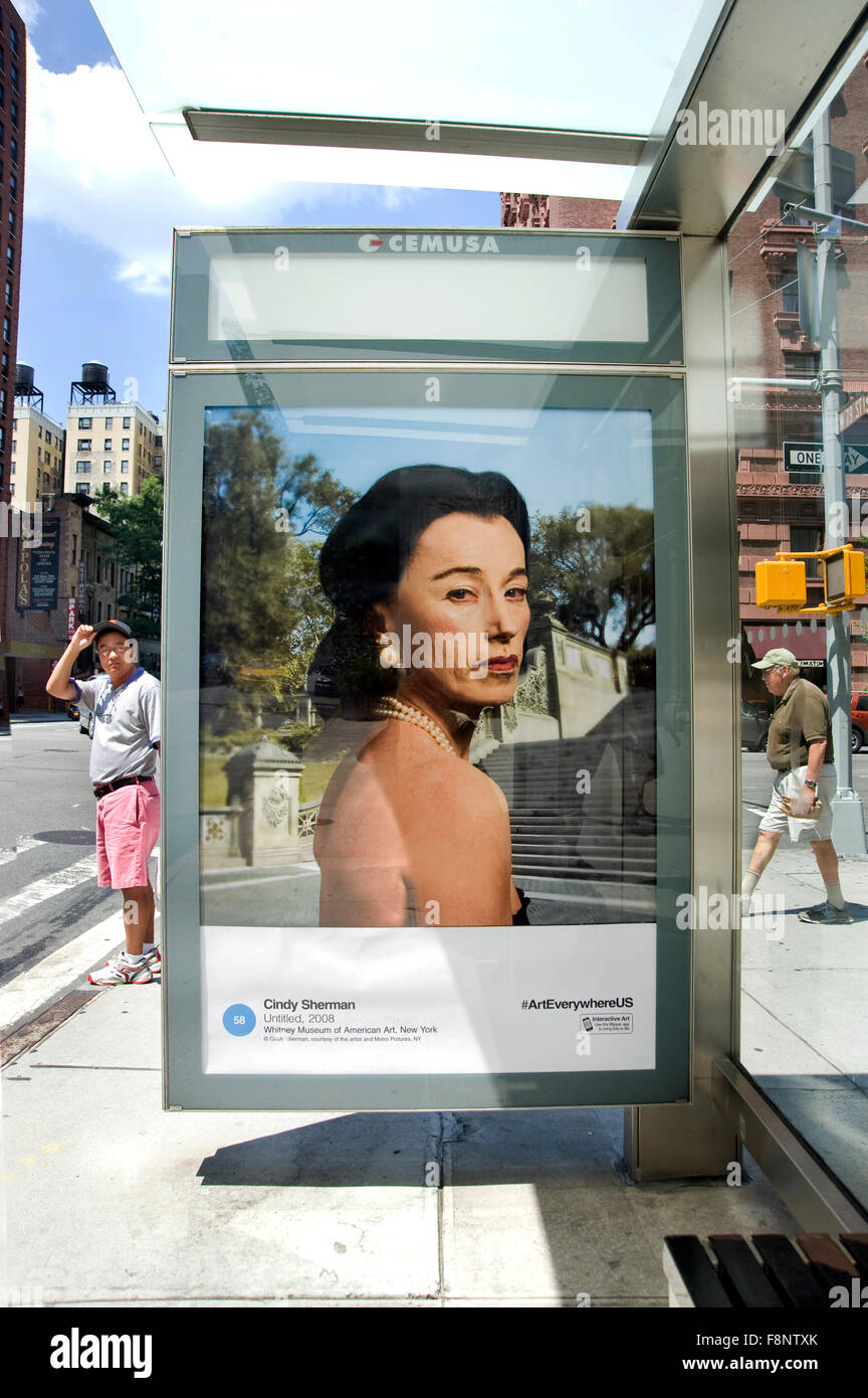 A Cindy Sherman fine art photograph is reproduced on a bus shelter ...