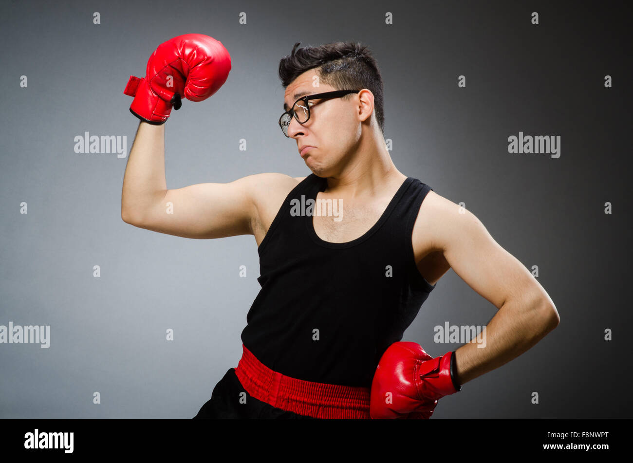 Funny boxer with red gloves against dark background Stock Photo - Alamy