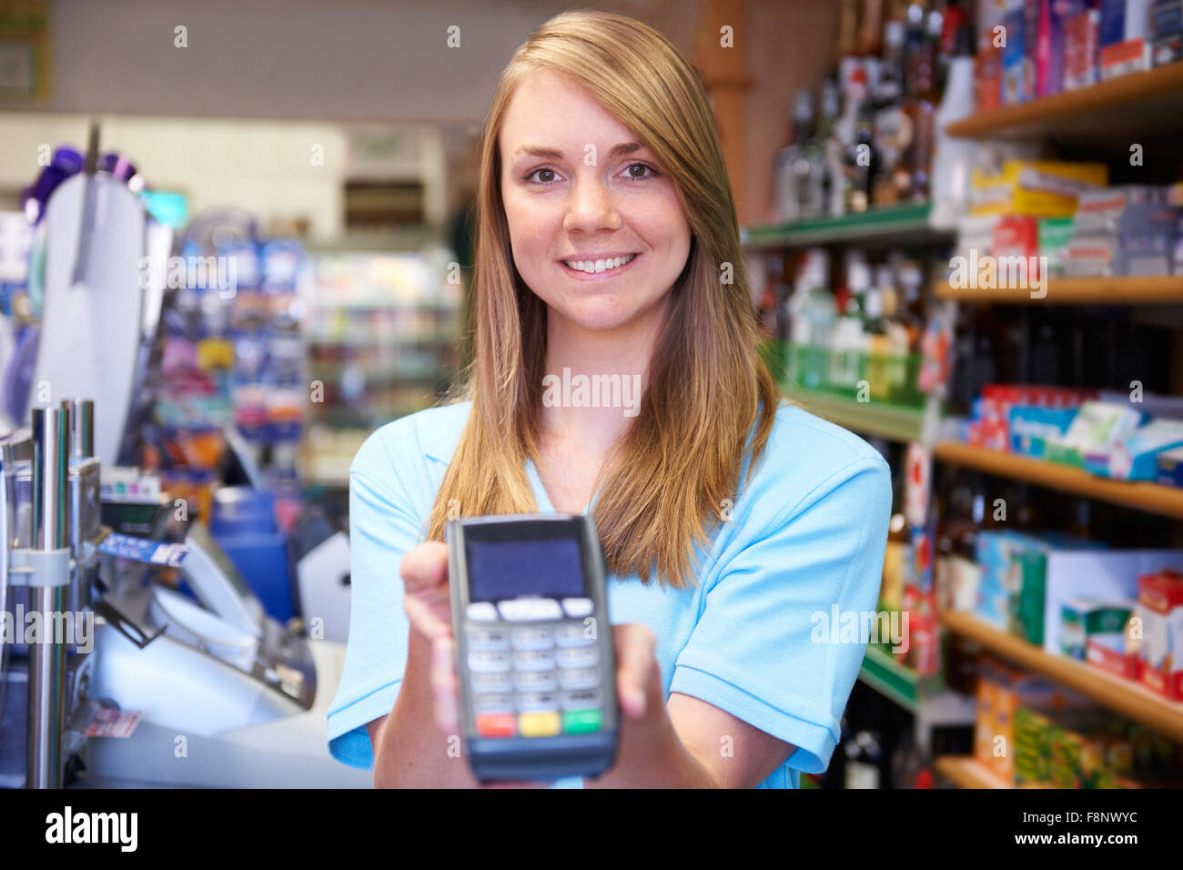 Female Sales Assistant Holding Credit Card Machine Stock Photo - Alamy