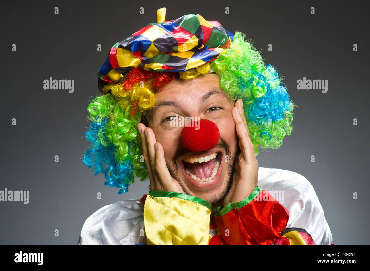 Funny clown in colourful costume Stock Photo - Alamy