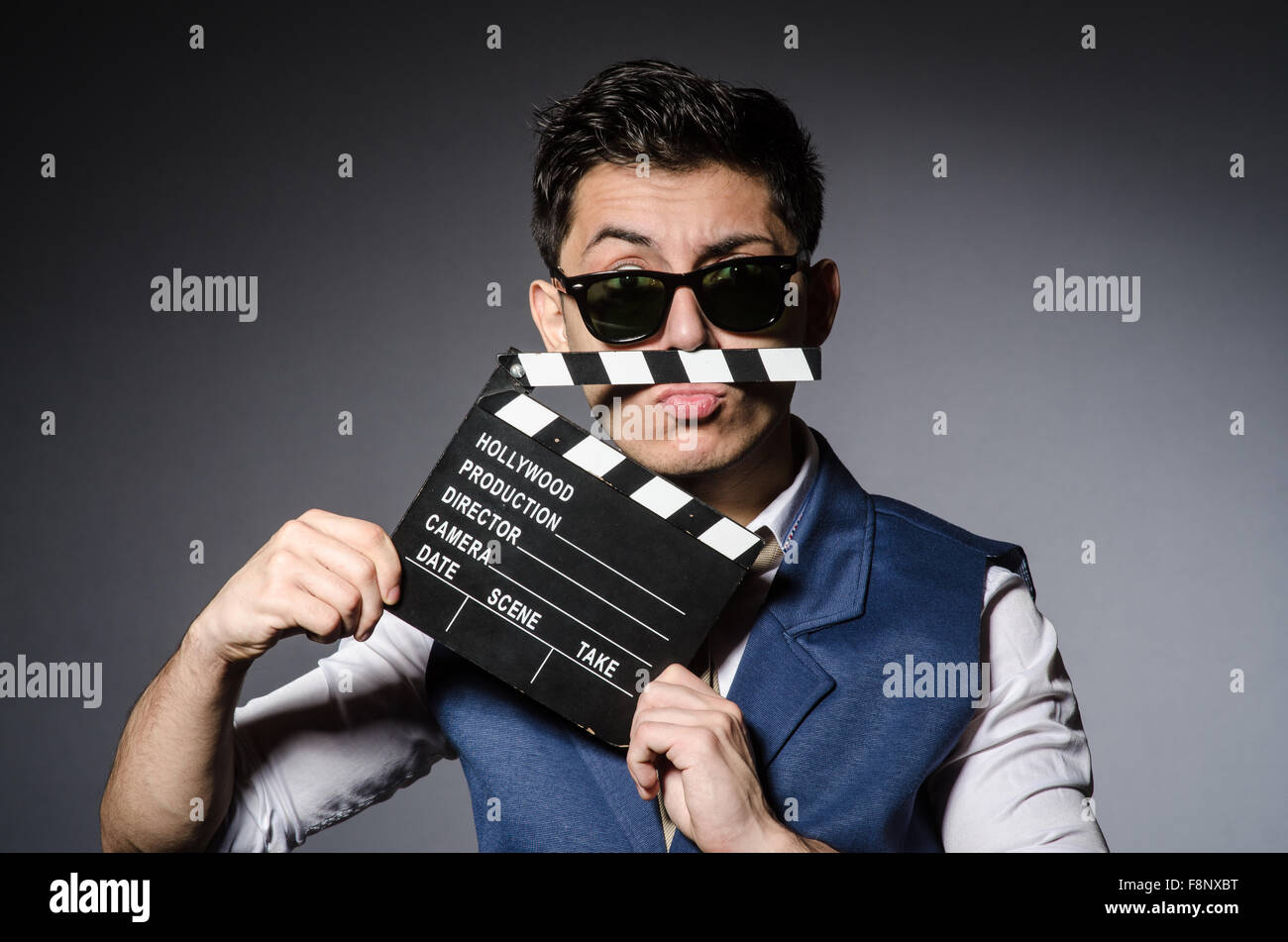 Funny man with movie clapboard Stock Photo - Alamy