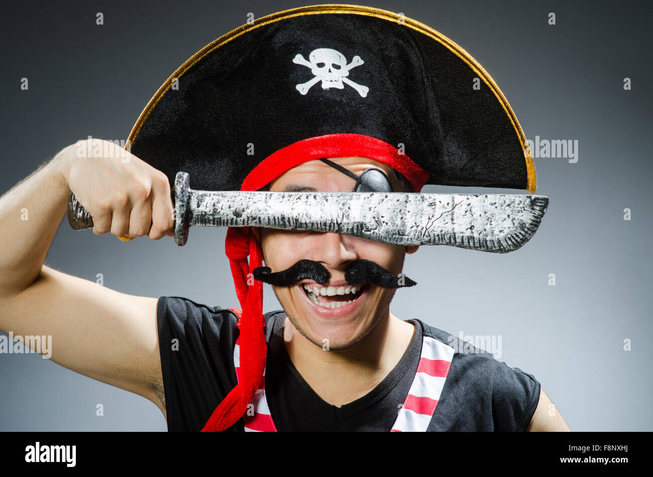 Funny pirate in the dark studio Stock Photo - Alamy