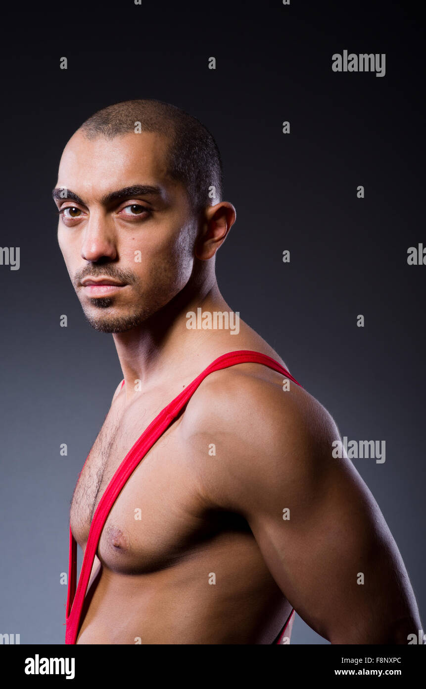 Wrestler in red dress against dark background Stock Photo - Alamy