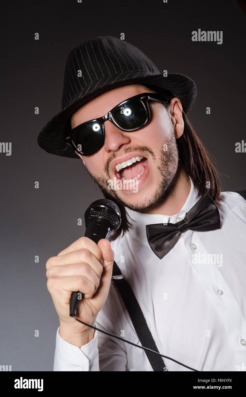 Funny singer with microphone at the concert Stock Photo - Alamy
