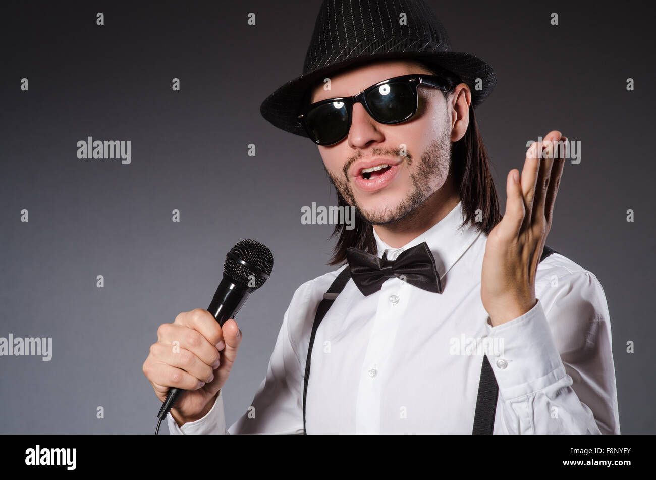 Funny singer with microphone at the concert Stock Photo - Alamy