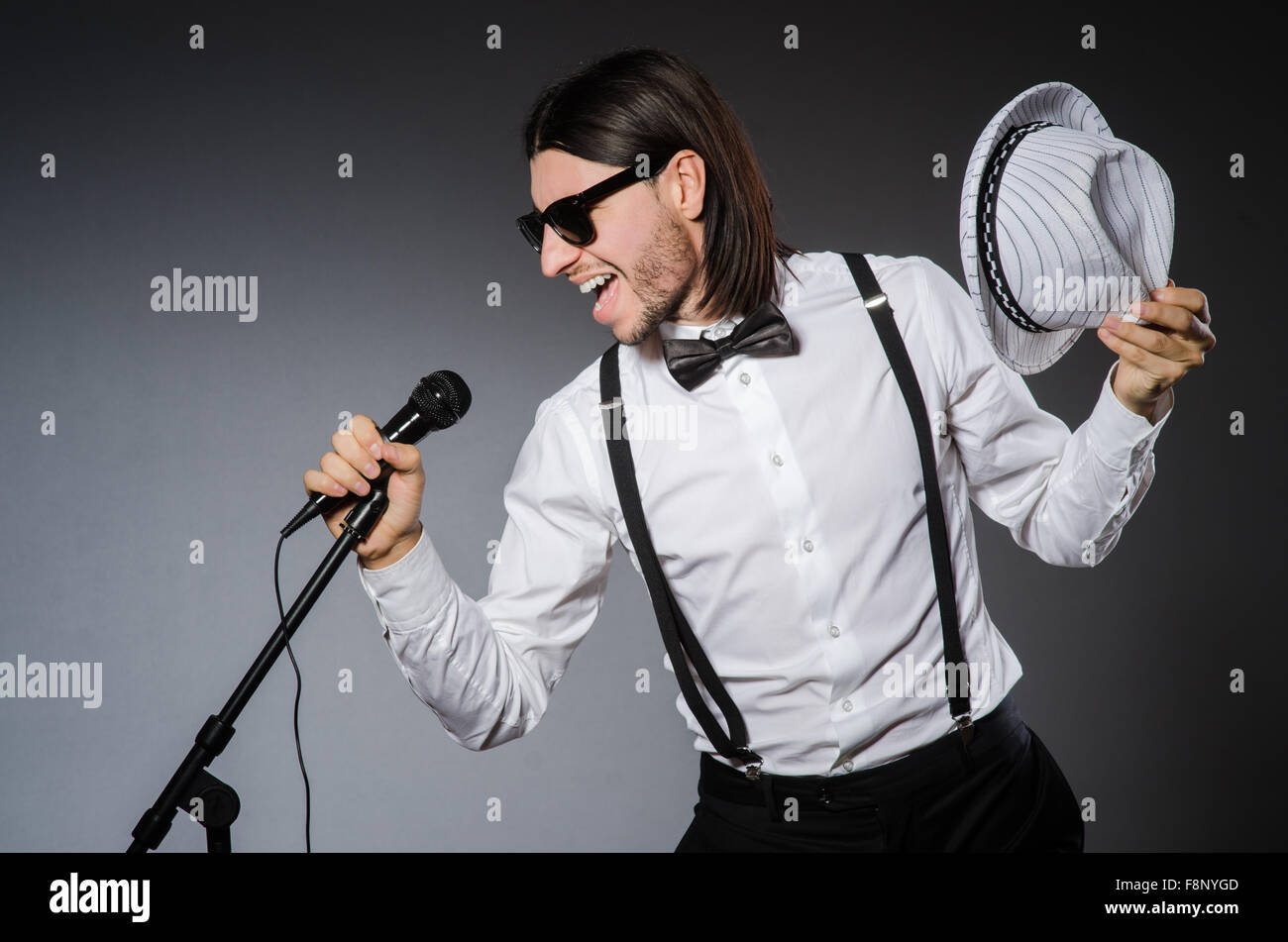 Funny singer with microphone at the concert Stock Photo - Alamy
