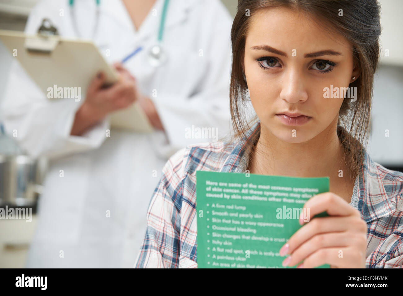 Teenage Girl Reading Leaflet In Doctor's Surgery Stock Photo - Alamy