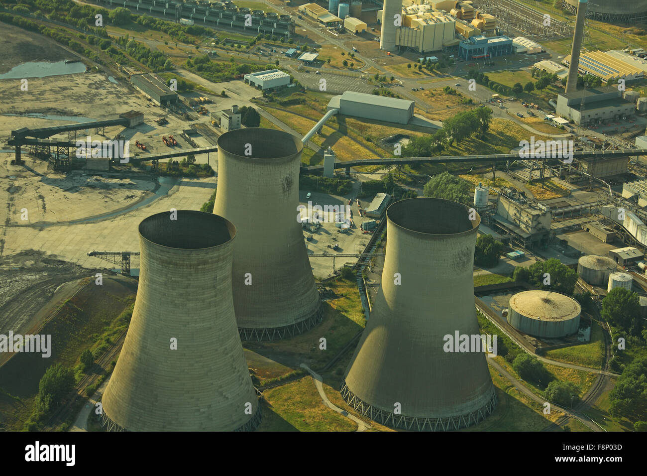 An aerial view of three cooling towers and part of a power station ...