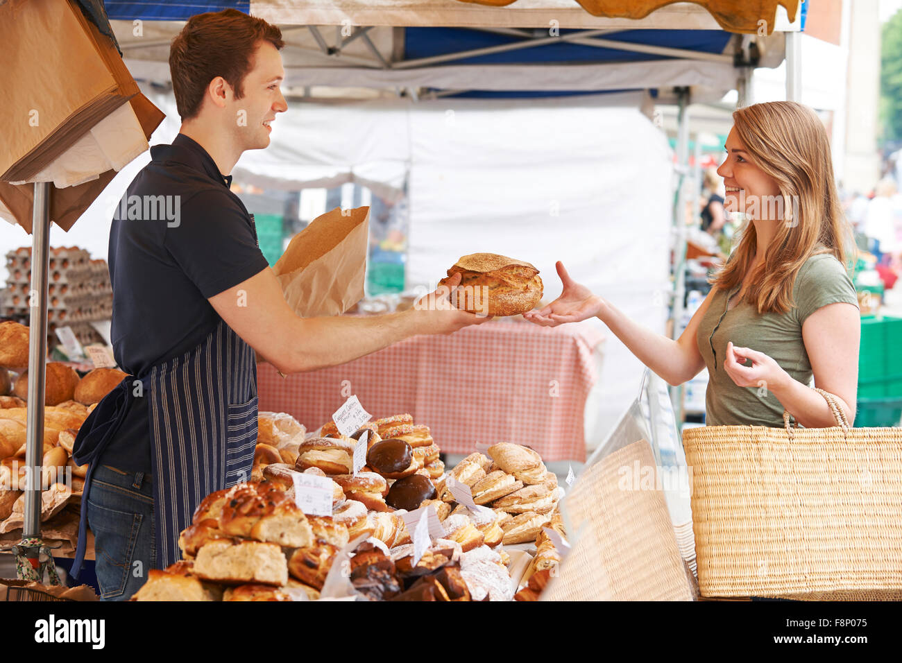 Customer Buying Loaf From Market Bread Stall Stock Photo - Alamy