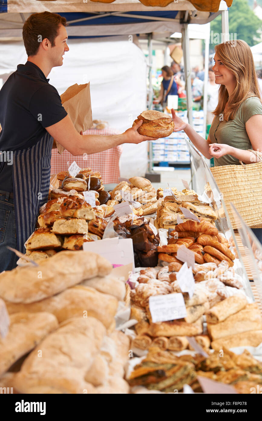 Customer Buying Loaf From Market Bread Stall Stock Photo - Alamy