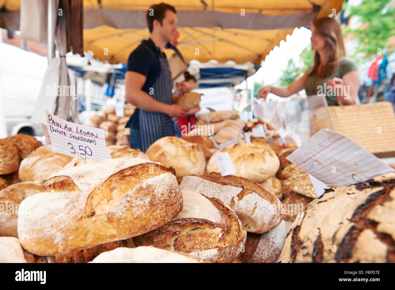 Customer Buying Loaf From Market Bread Stall Stock Photo - Alamy