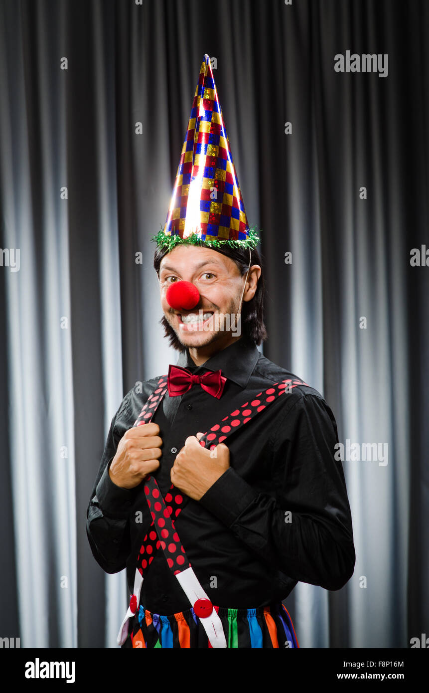 Funny clown in humorous concept against curtain Stock Photo - Alamy