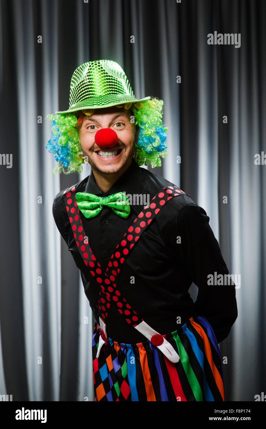 Funny clown in humorous concept against curtain Stock Photo - Alamy