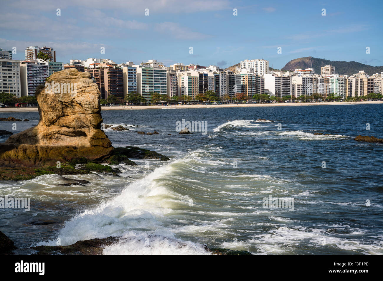 Sea rock and view of the high-rise development along the central beach ...