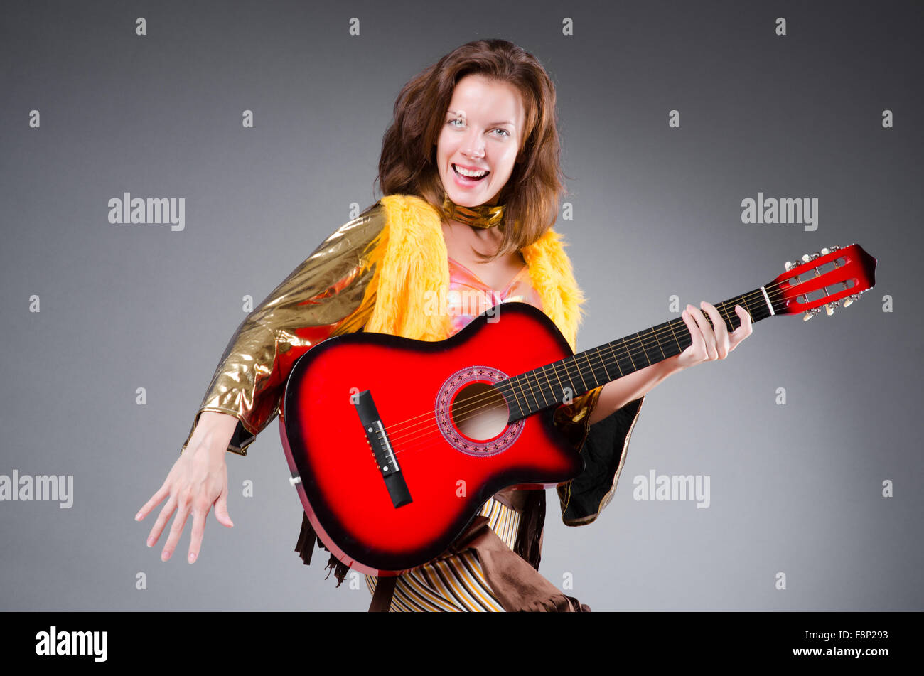 Guitar player with red instrument Stock Photo - Alamy
