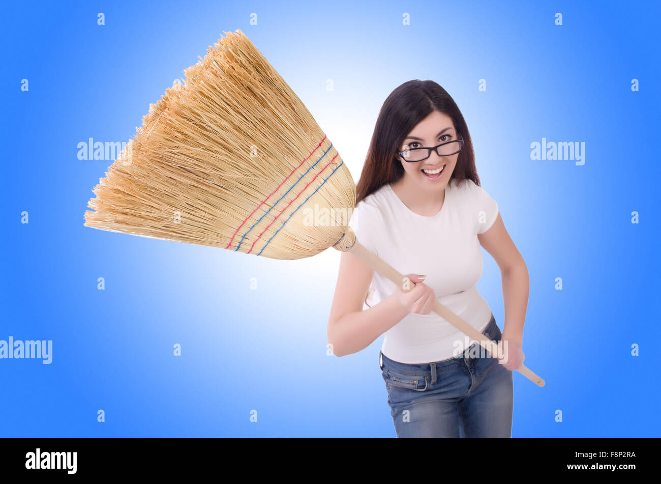 Young woman with broom on white Stock Photo - Alamy