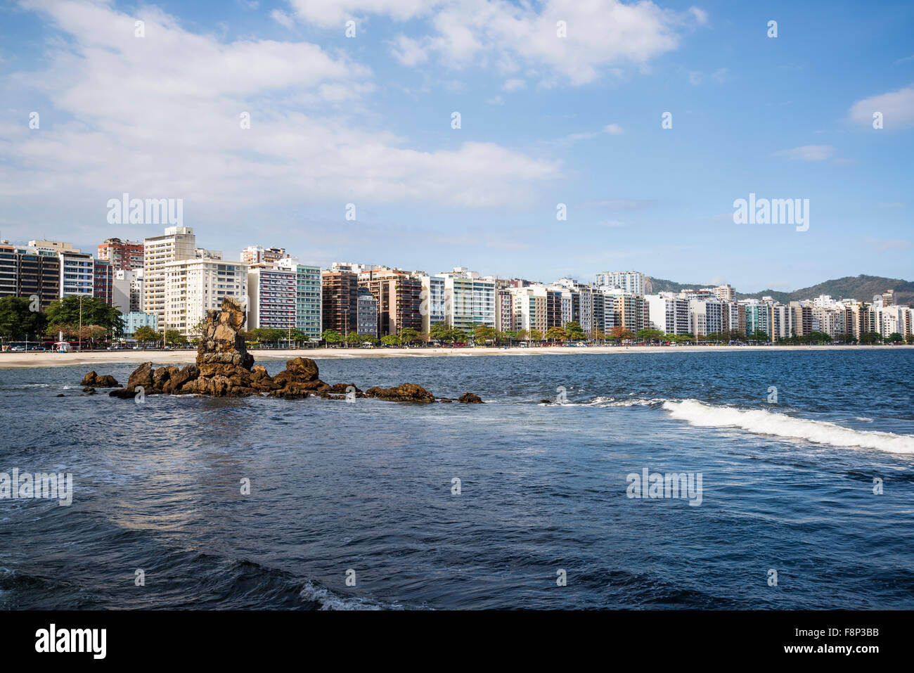 Sea rock and view of the high-rise development along the central beach ...