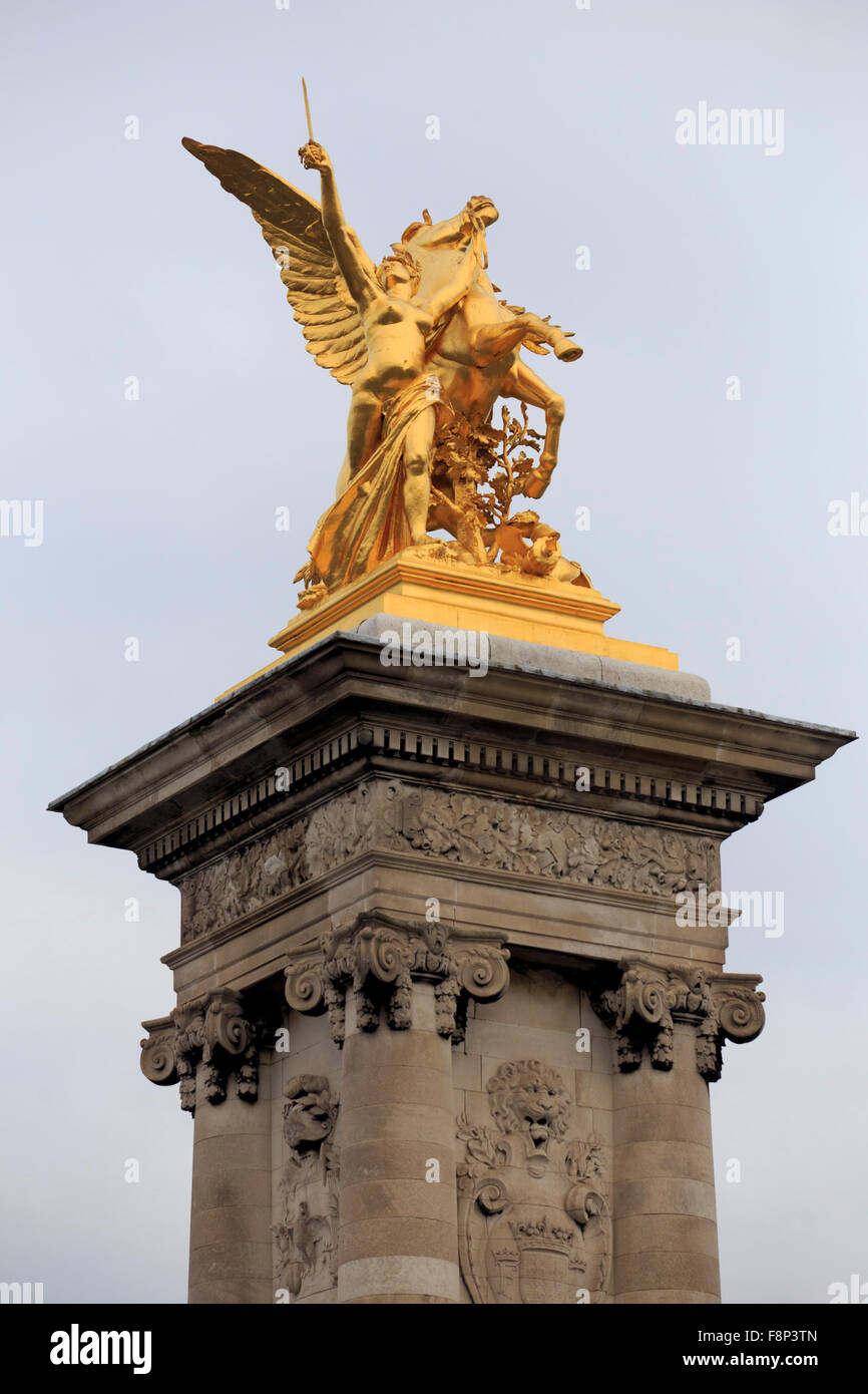 Golden statues atop pillars on the streets of Paris, France near Les ...