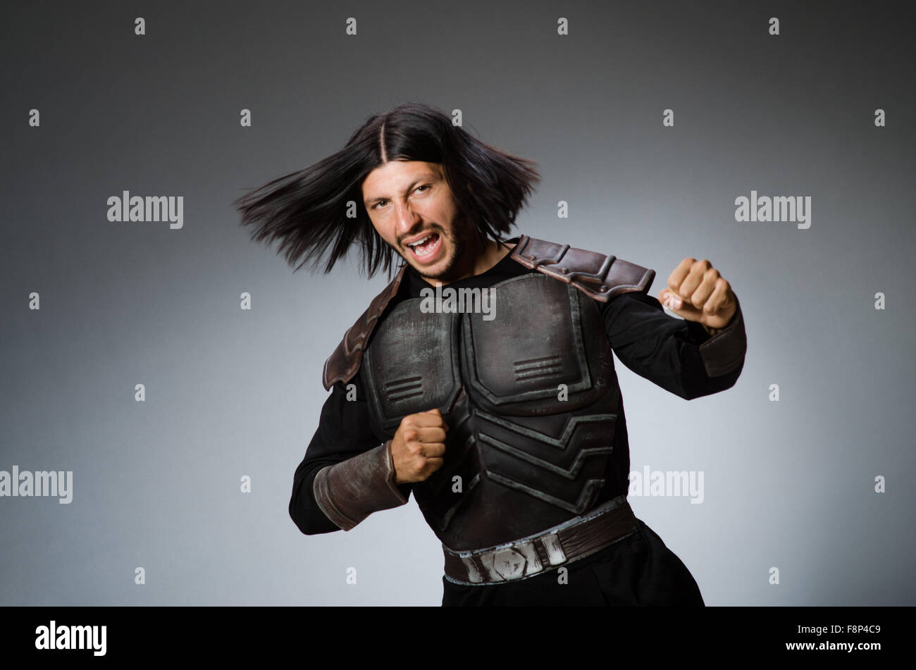Angry warrior against dark background Stock Photo - Alamy