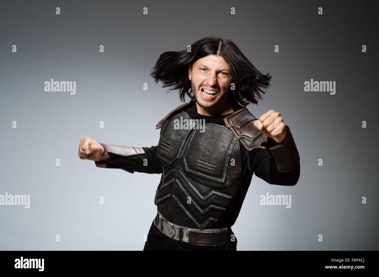 Angry warrior against dark background Stock Photo - Alamy