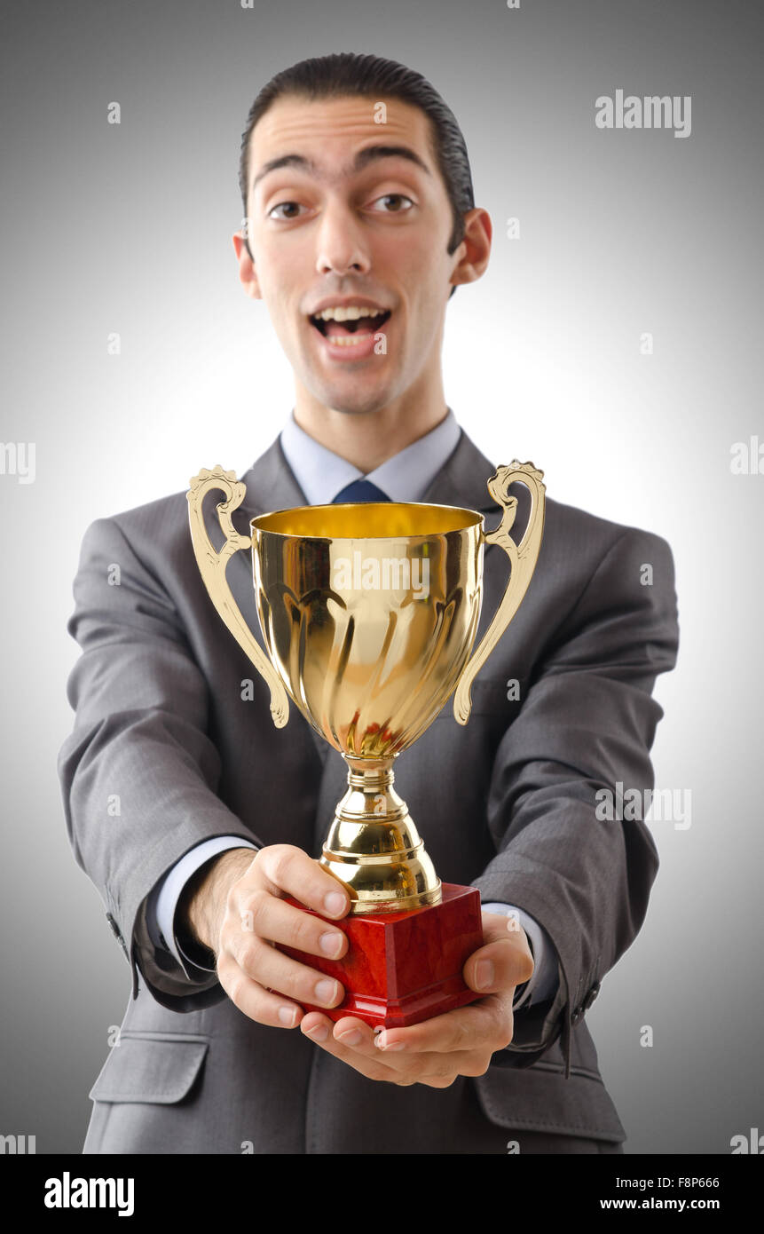 Man being awarded with golden cup Stock Photo - Alamy