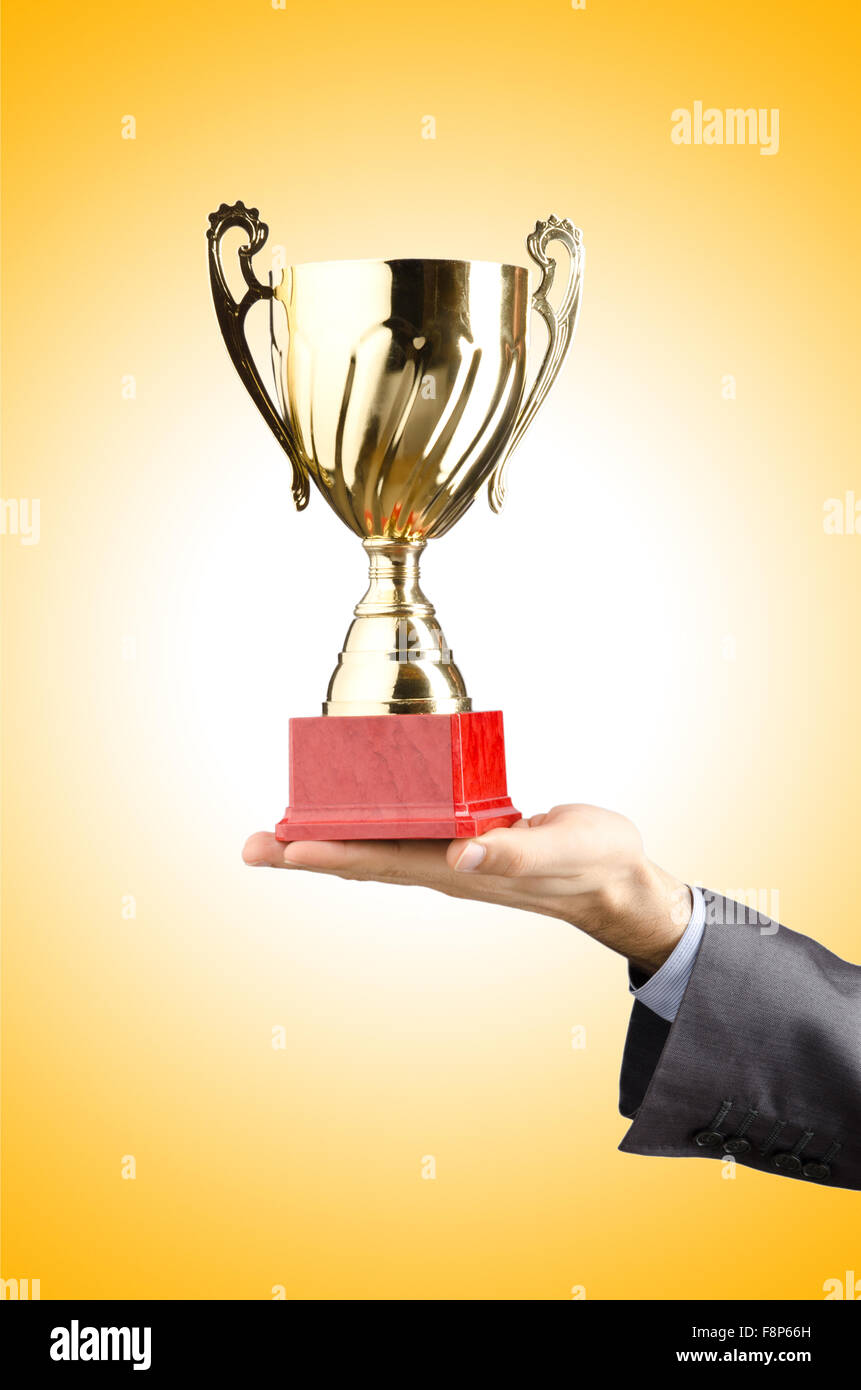 Man being awarded with golden cup Stock Photo - Alamy