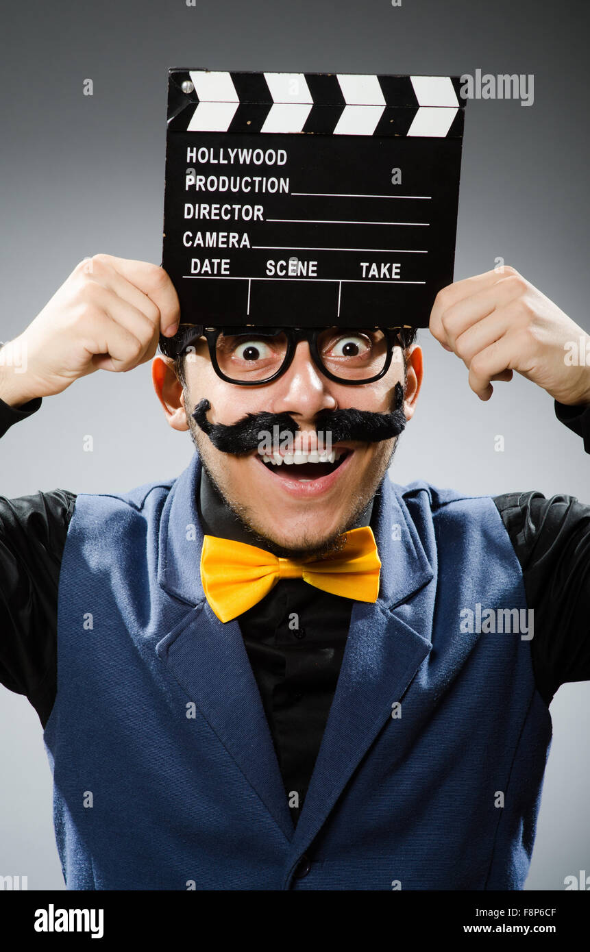 Funny man holding movie clapper Stock Photo - Alamy