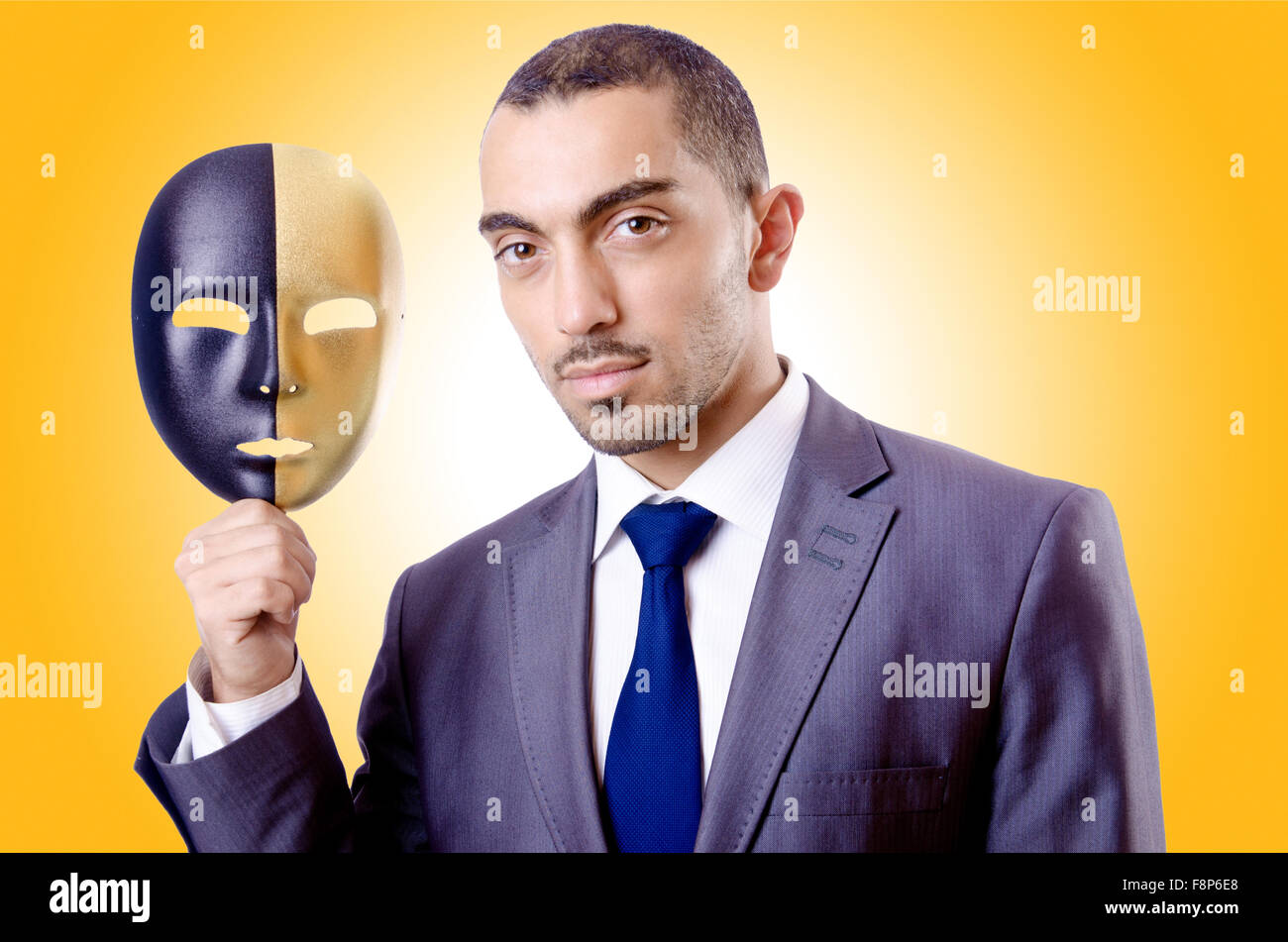 Businessman with mask in hypocrisy concept Stock Photo - Alamy