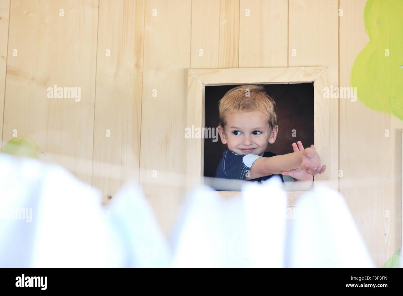 happy cute child in a wooden window at playground Stock Photo - Alamy
