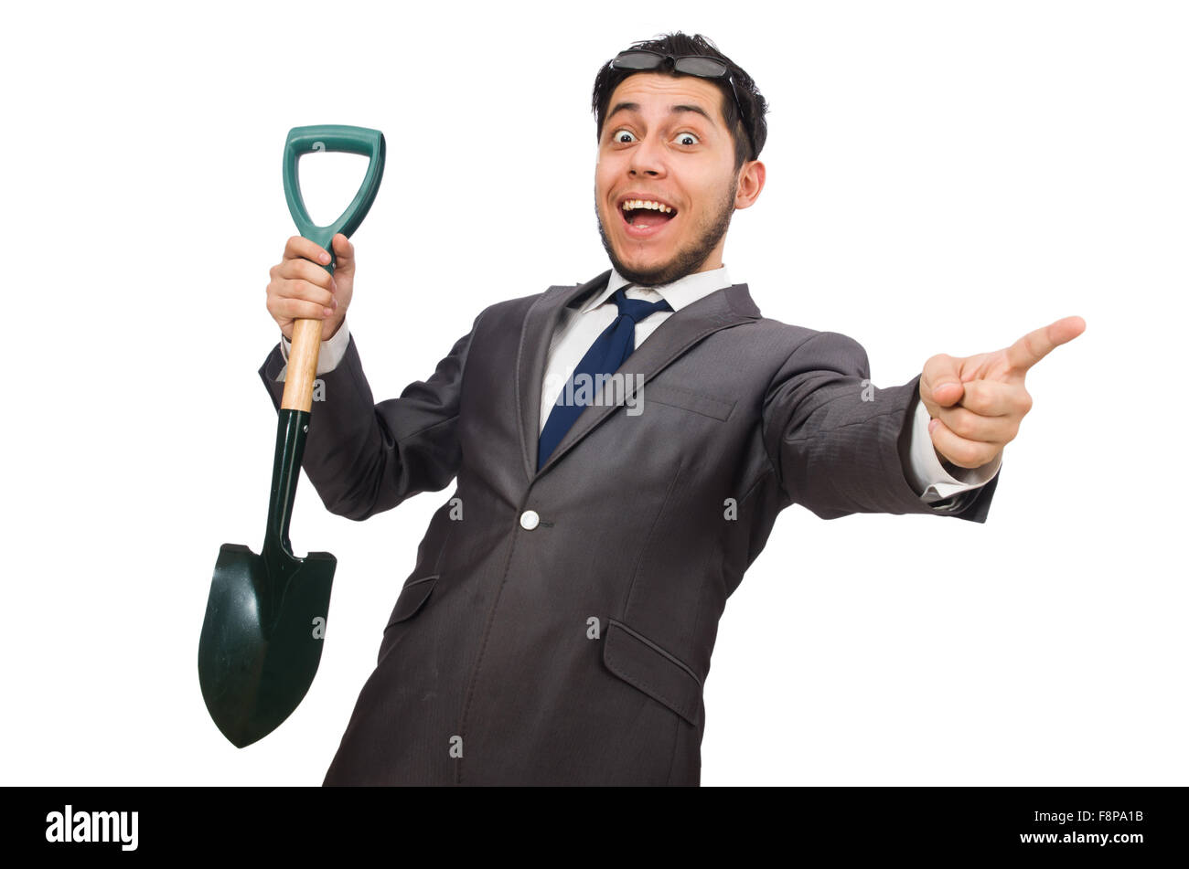 Young businessman holding a spade isolated on white Stock Photo - Alamy