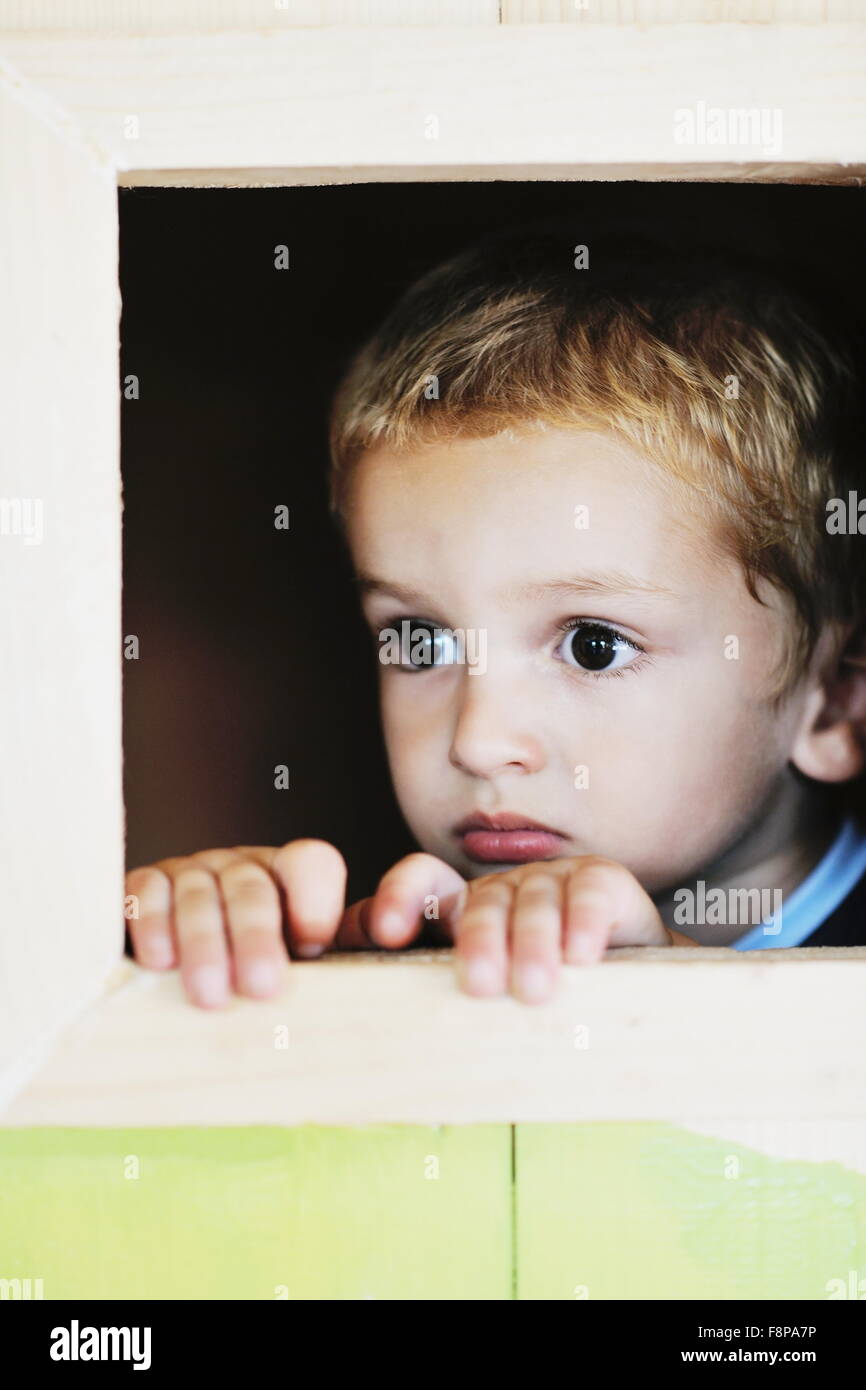 happy cute child in a wooden window at playground Stock Photo - Alamy