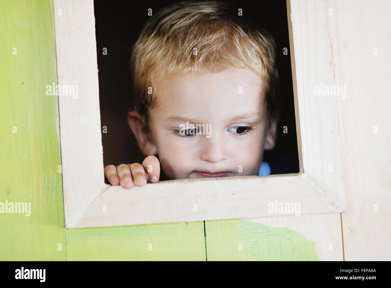 happy cute child in a wooden window at playground Stock Photo - Alamy