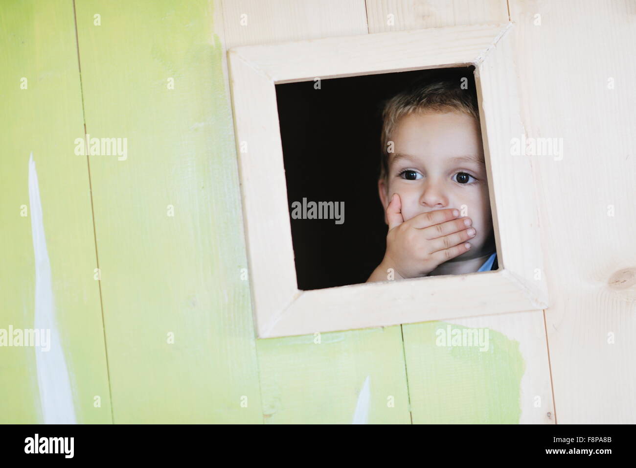 happy cute child in a wooden window at playground Stock Photo - Alamy
