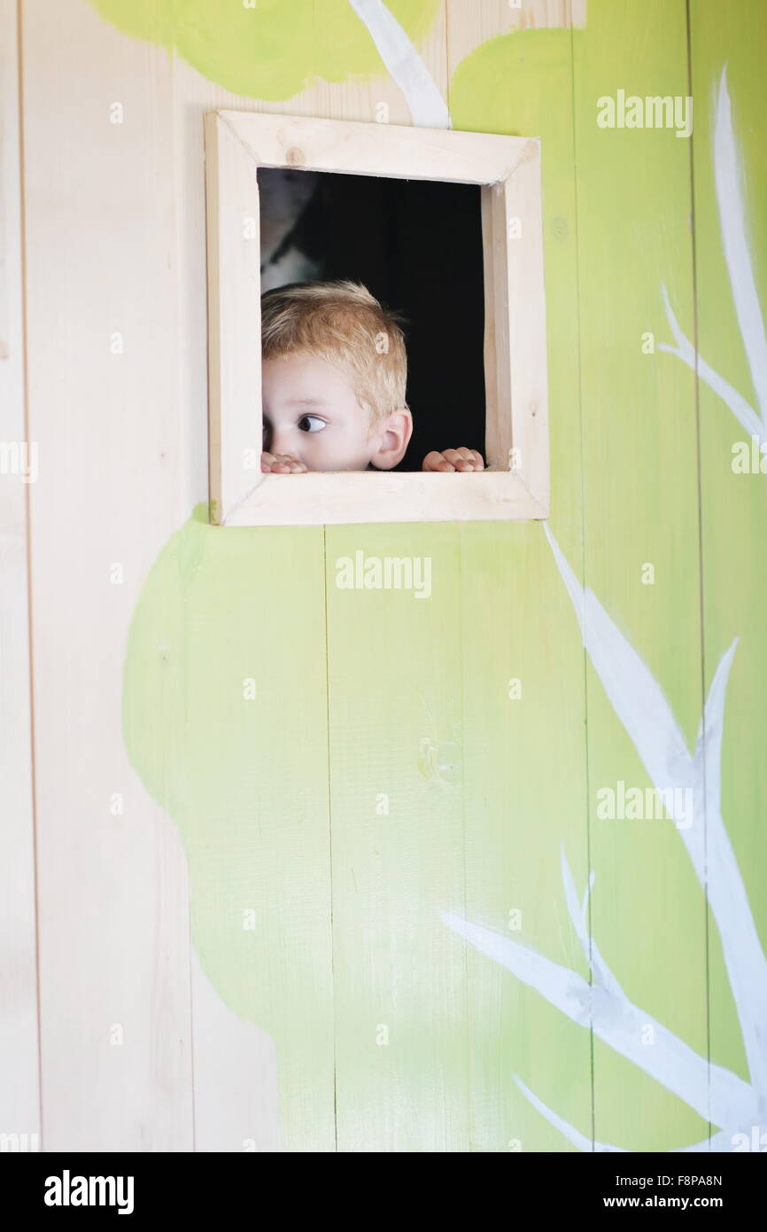 happy cute child in a wooden window at playground Stock Photo - Alamy